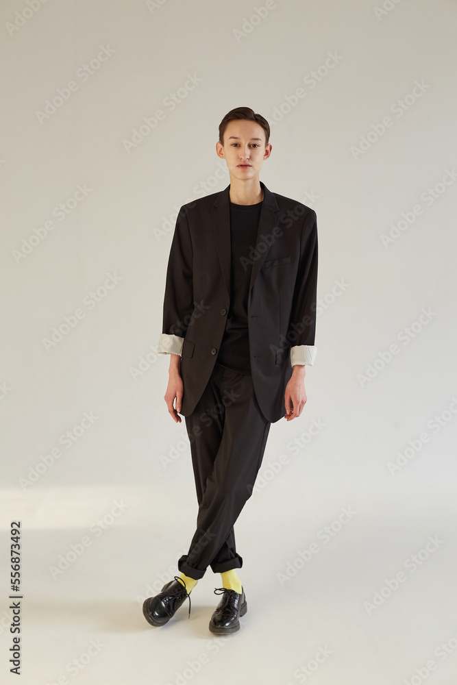 Attractive gender neutral model with short hair wearing elegant male ...