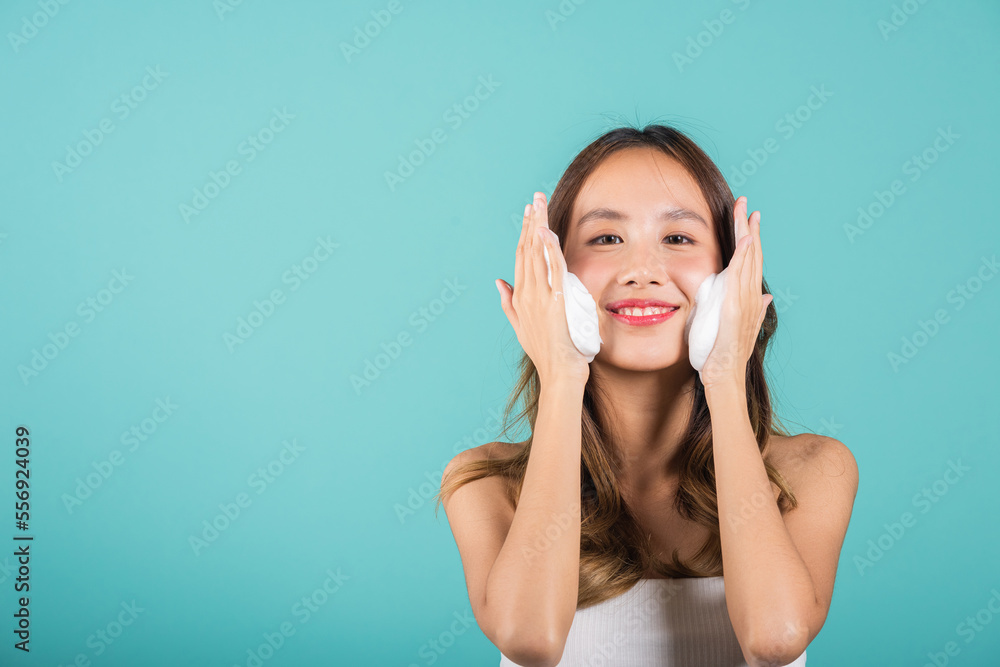 Portrait beautiful female smile applies foaming cleanser healthy skin ...