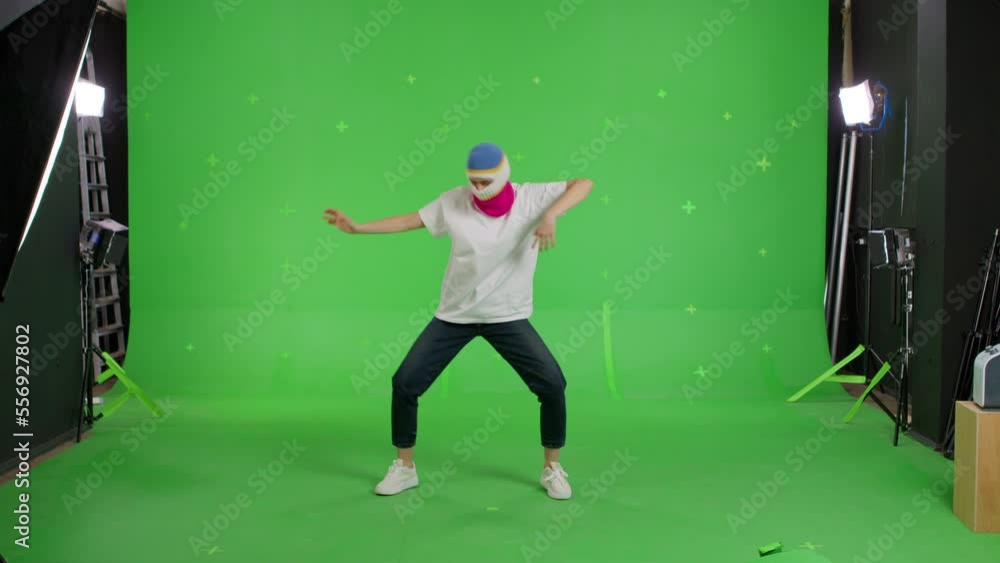 Girl in white t-shirt, jeans and sneakers dancing on a Green Screen ...