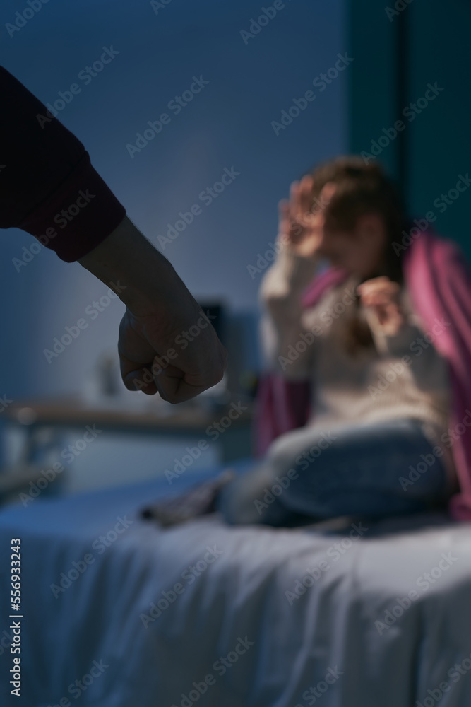 The concept of domestic abuse of a child by father. A man standing with ...