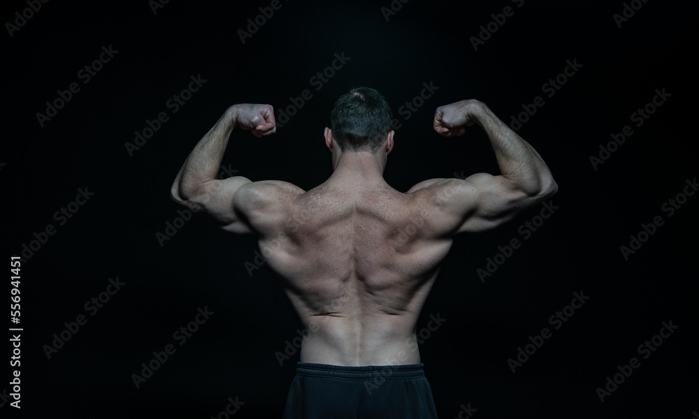 bodybuilder man muscular back in black studio. bodybuilder man muscular ...