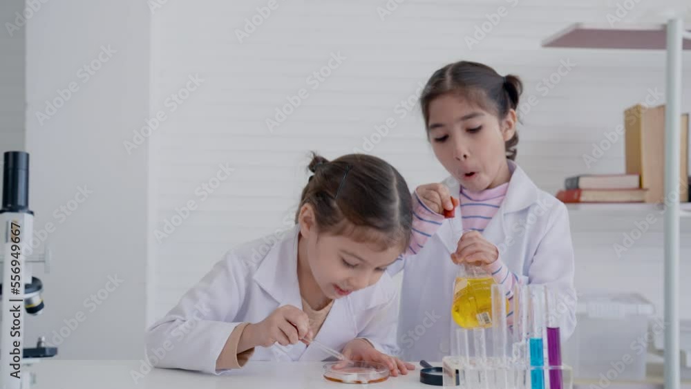 4K, Two schoolgirls, wearing white glued shirts, in science room, two ...