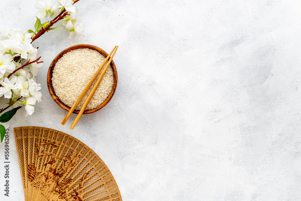 Chinese or Japanese background with bowl of rice and fan, top view ...