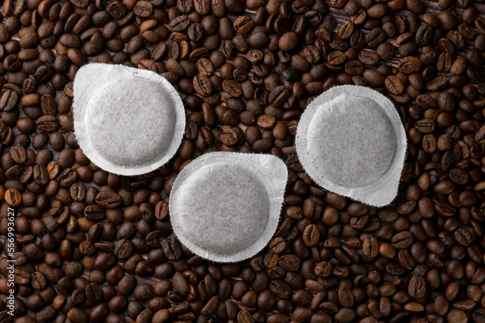 Paper pods for coffee machine on coffee beans background Stock Photo ...