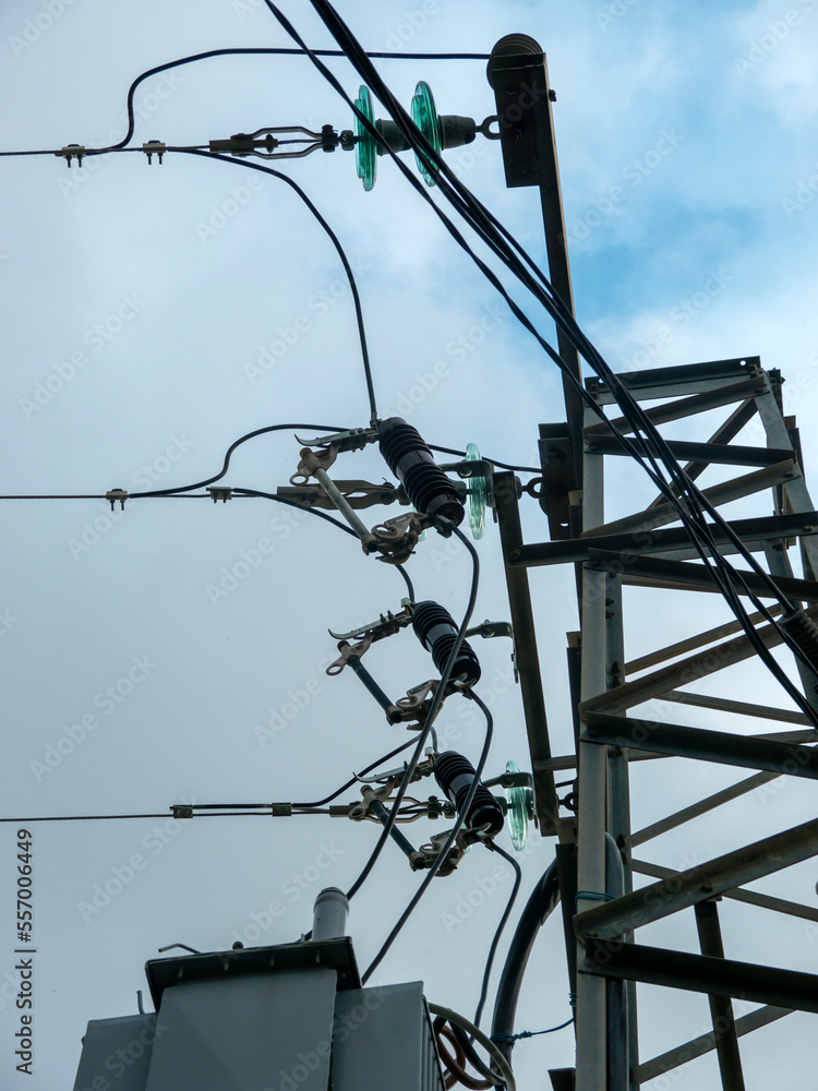 Electrical transformer tower with equipment and wire lines below view ...
