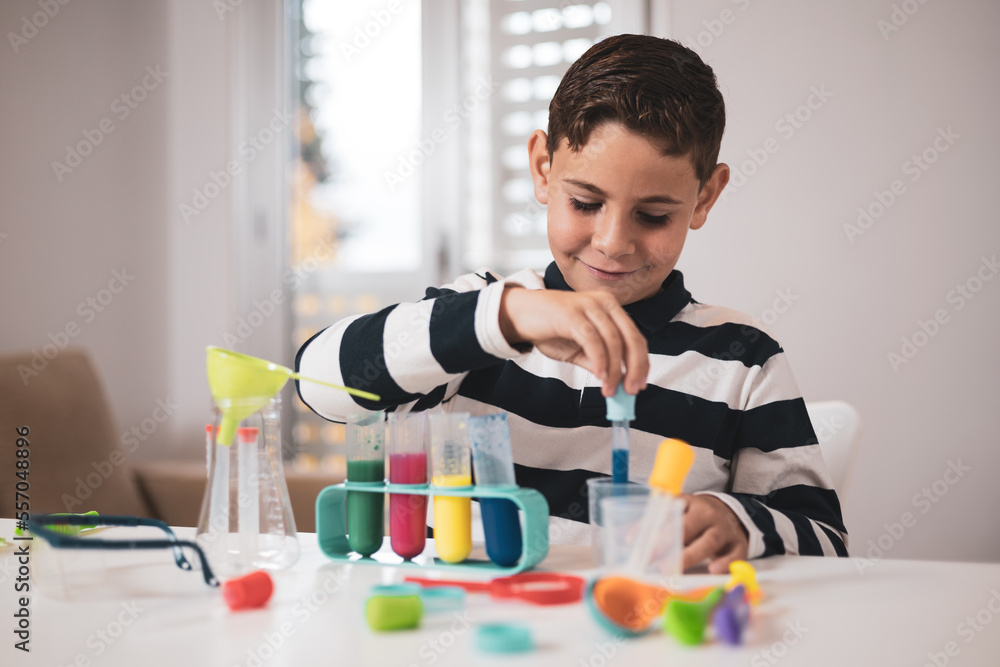 Child having fun with the chemistry laboratory in the living room of ...