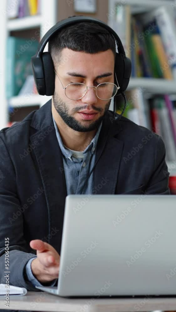 Vertical Screen: Bearded man with eyeglasses using headphones and ...