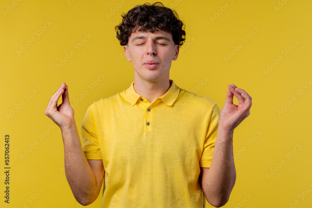 Calm man relaxing, meditating, refuses stress. Curly haired guy ...