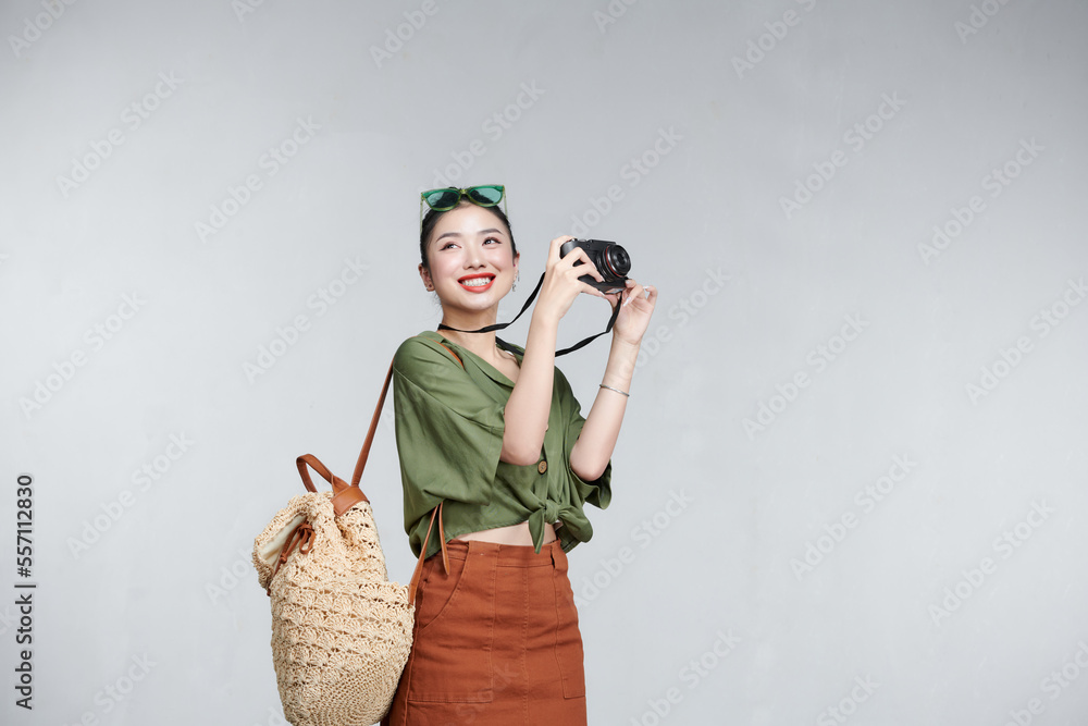 Beautiful young female traveler with camera and backpack Stock Photo ...