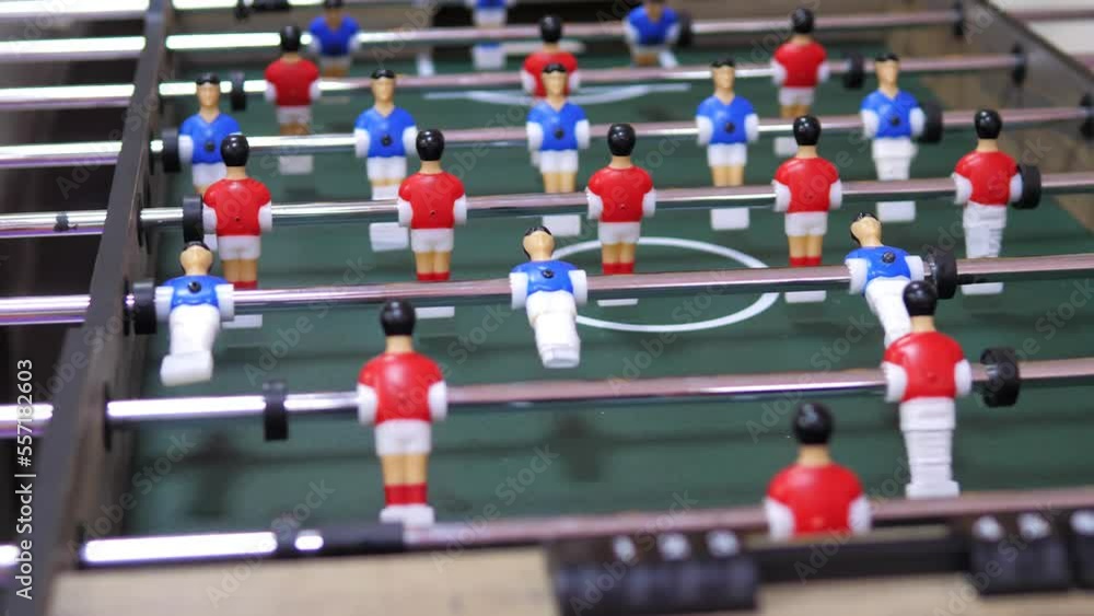 Two happy and joyful friends together playing table football in the ...