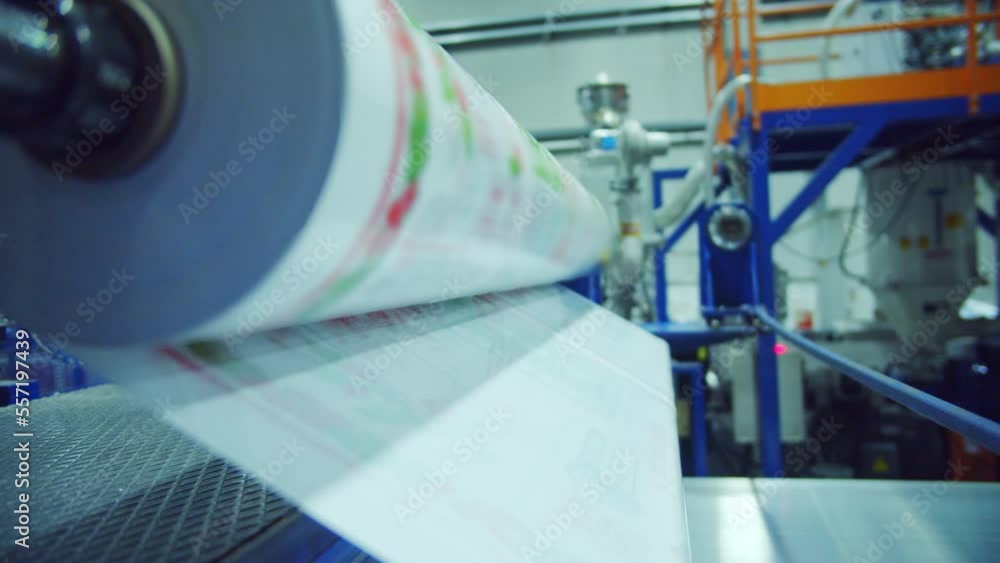 Machinery equipment unrolls monolithic polycarbonate sheet moving on ...