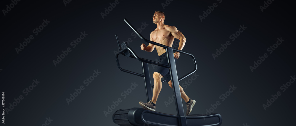 Shirtless Male athlete running on Motorless Curved Sprint Treadmill ...