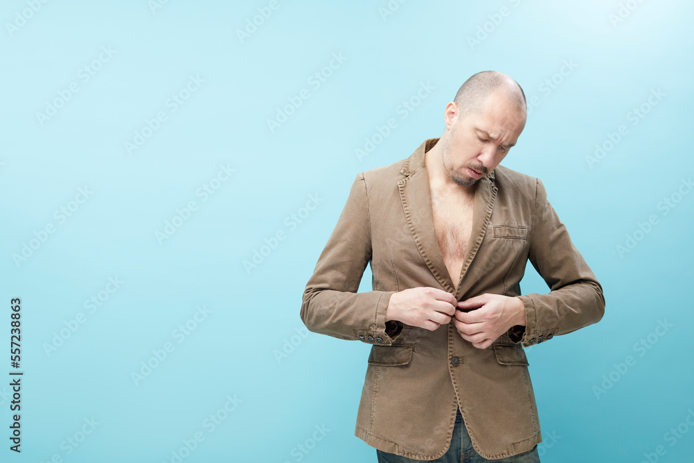 European bald man wearing brown jacket clad half naked body on blue ...