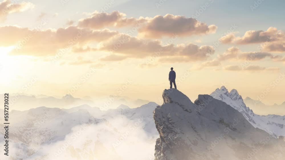 Adventurous Man Hiker standing on top of icy peak with rocky mountain ...