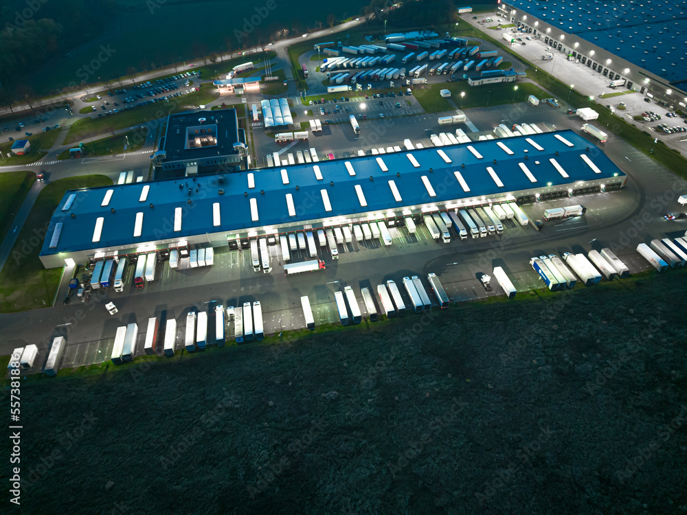 Aerial view of goods warehouse at Night. Logistics center in industrial ...