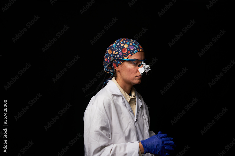 Female doctor in a white coat, blue nitrile gloves and microsurgery ...
