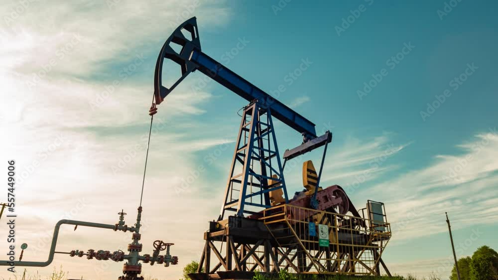 Time lapse of oil pump at an oil drilling site at sunset. Pump jack ...