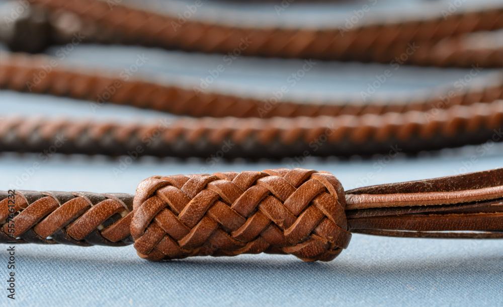 Intricate long leather knot tied from a single strand of leather in a ...