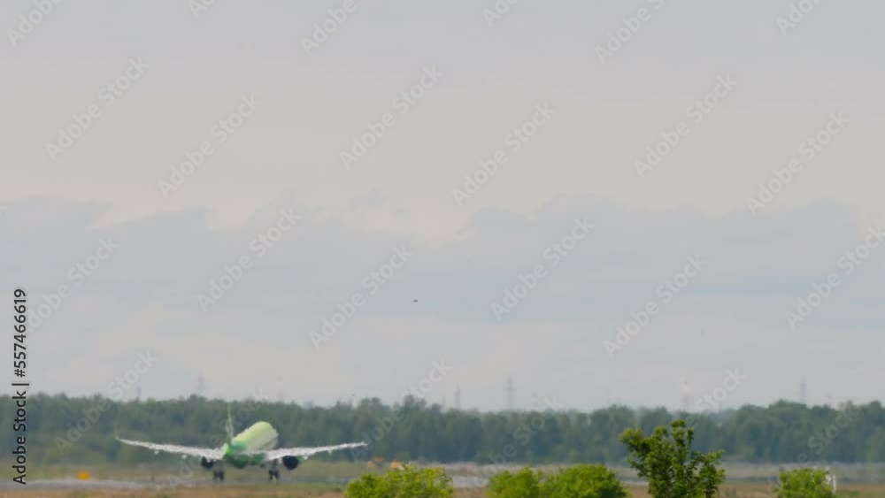 Unrecognizable jet plane departure, climb, rear view. Commercial ...