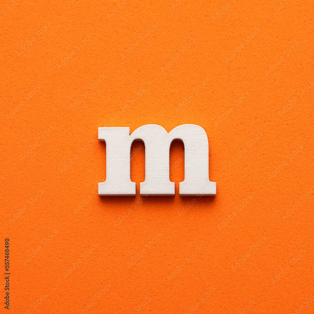 m white lowercase letter - Background in orange foamy Stock Photo ...
