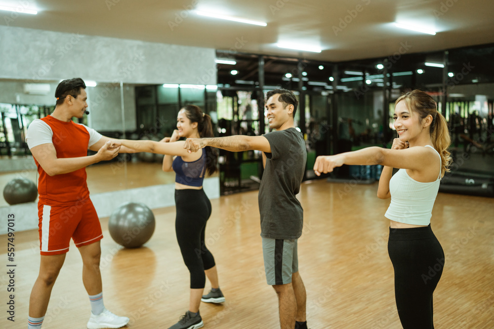 several people make hitting movements with male instructors during body ...