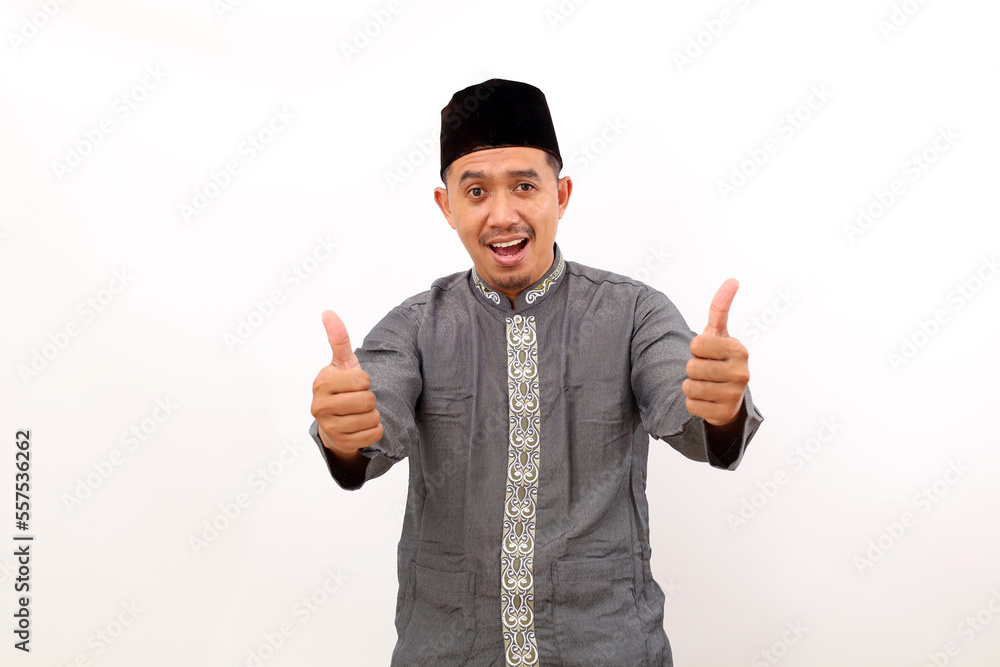 Happy asian muslim man standing while showing thumbs up. Isolated on ...