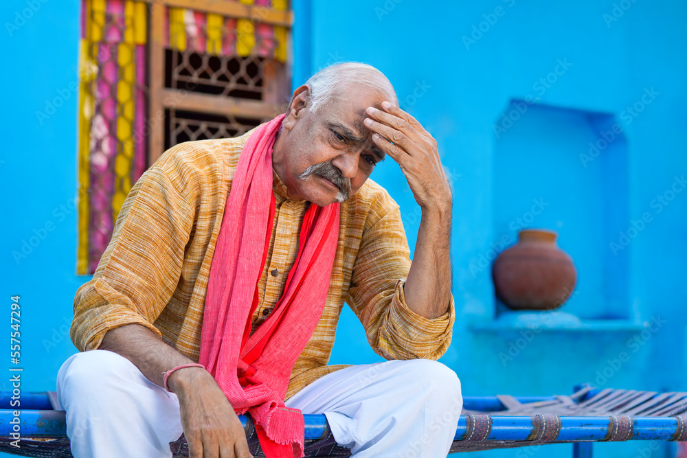 Indian farmer in depression at home. Stock Photo | Adobe Stock