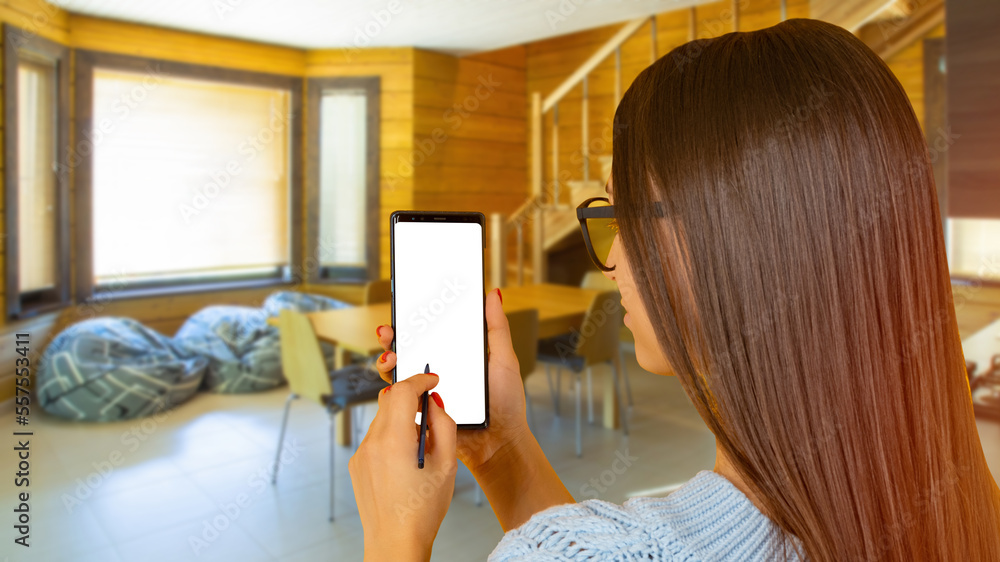 Woman is using phone. Girl with smartphone with her back to camera ...