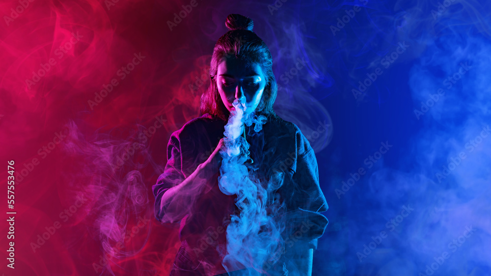 Woman smoker. Vaper blows smoke from his nose. Girl uses vape. Lady ...