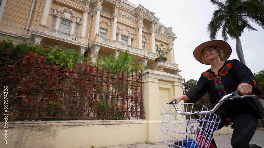 Smiling, happy, fun mature elderly woman in ethnic clothing and hat ...