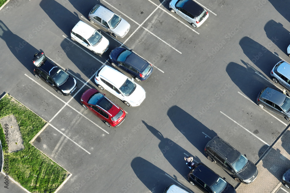 Aerial view of many colorful cars parked on parking lot with lines and ...