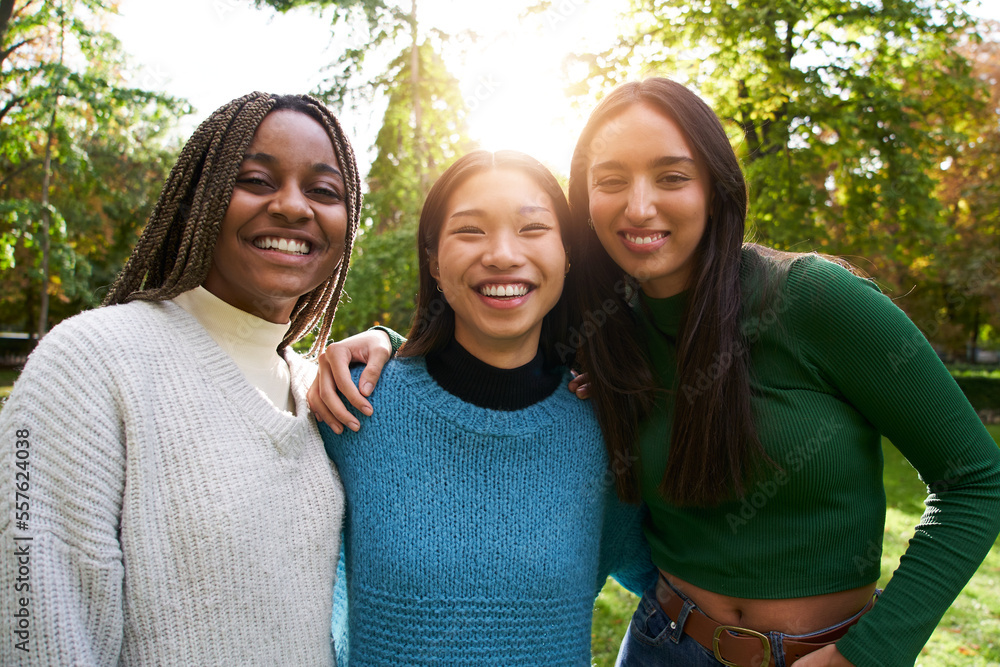 Portrait of three girls outside looking at the camera. An Asian Chinese ...