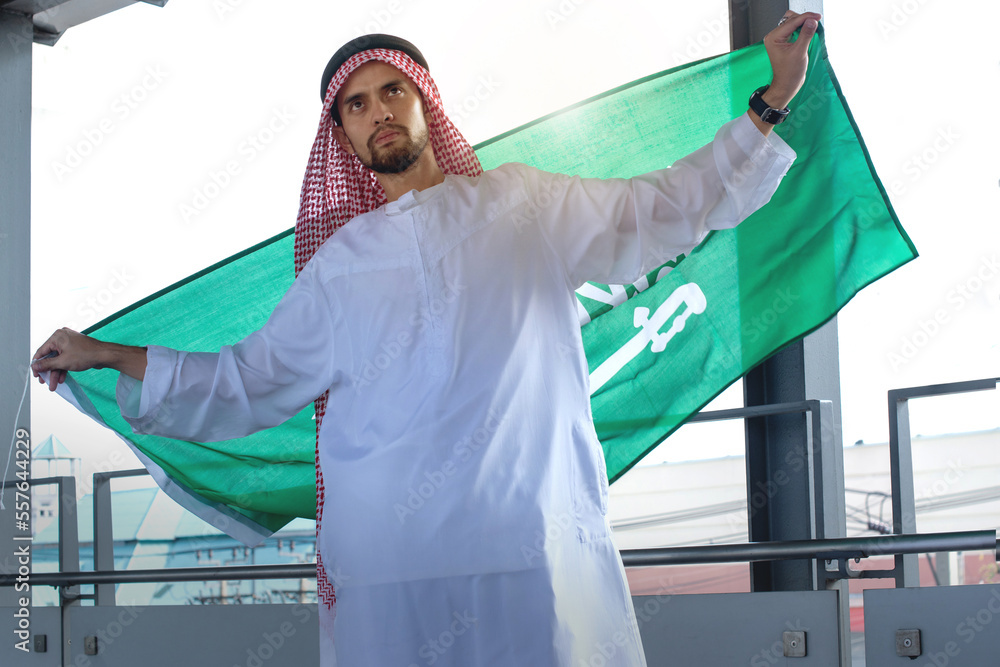 Portrait of Arab man holding Saudi Arabia flag on shoulder, celebrate ...
