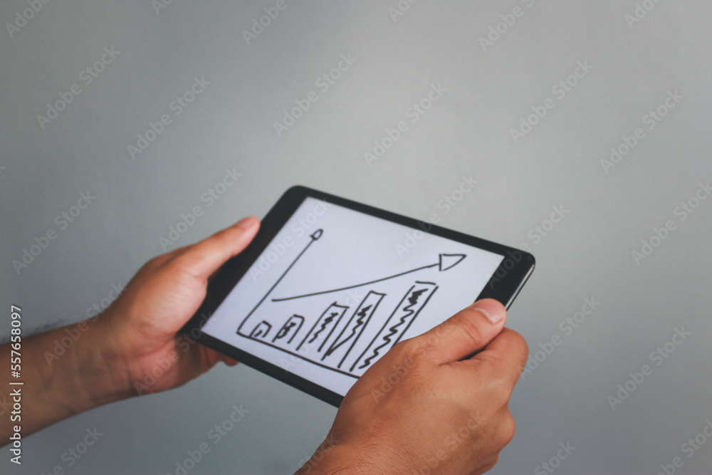 Hand holding tablet computer with digital screen displaying QR code ...