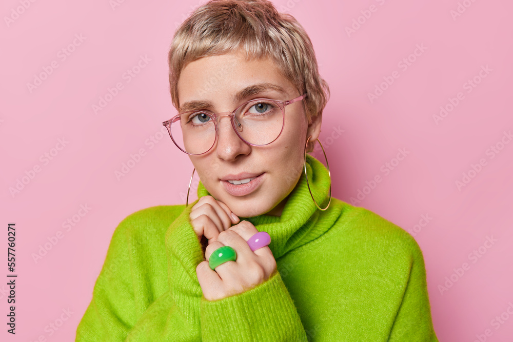 Portrait of serious good looking adult woman looks directly at camera ...
