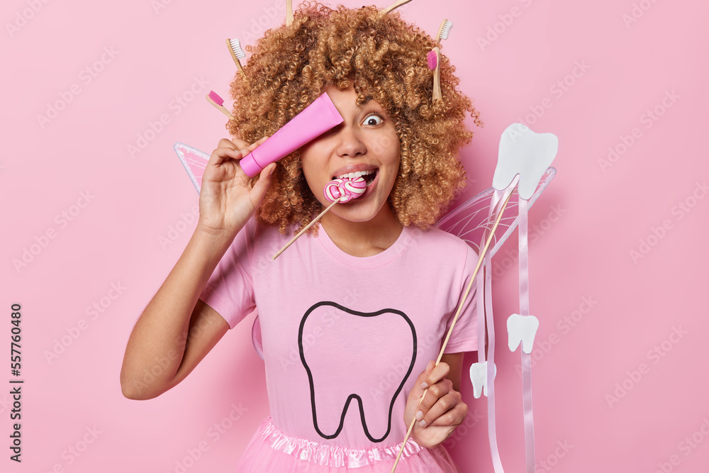 Photo of curly haired European woman dressed like tooth fairy covers ...