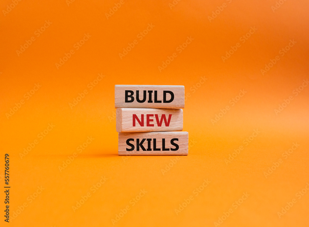 Build New skills symbol. Concept word Build New skills on wooden blocks ... Build New skills symbol. Concept word Build New skills on wooden blocks ...
