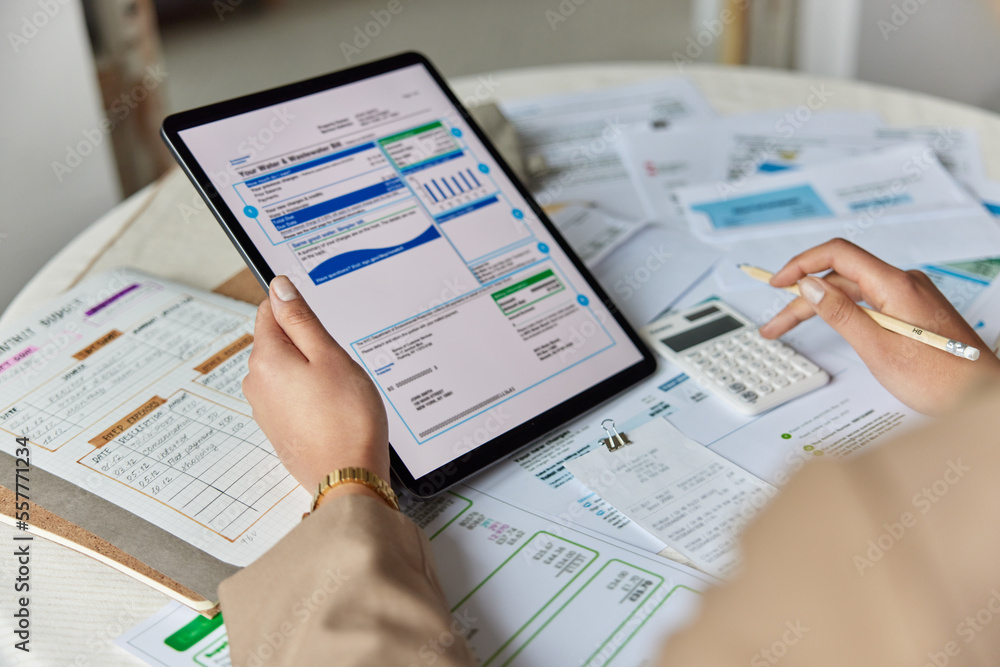 Financial paperwork. Unrecognizable person performs arithmetic ...