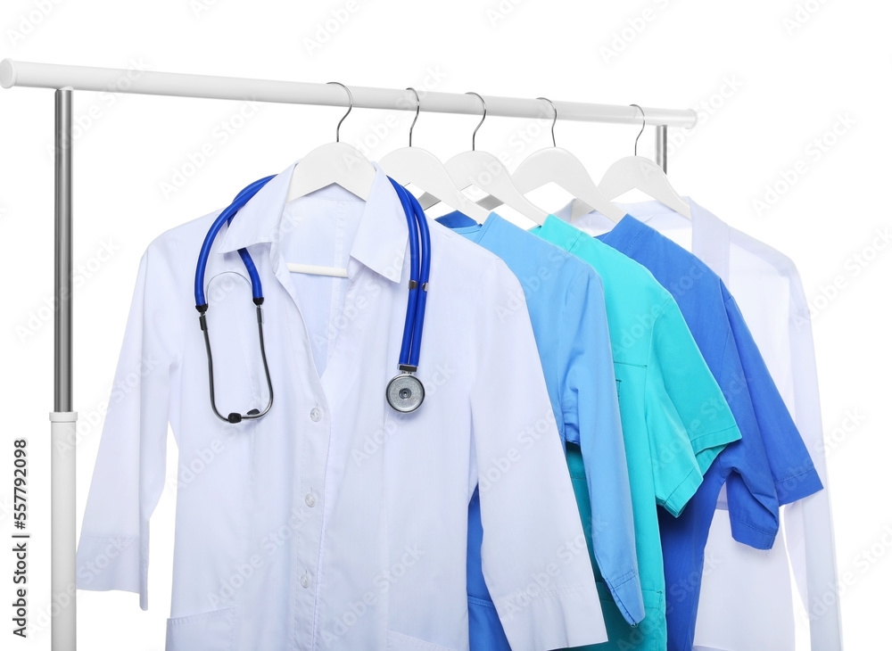 Doctor's gown with stethoscope and different medical uniforms on rack ...