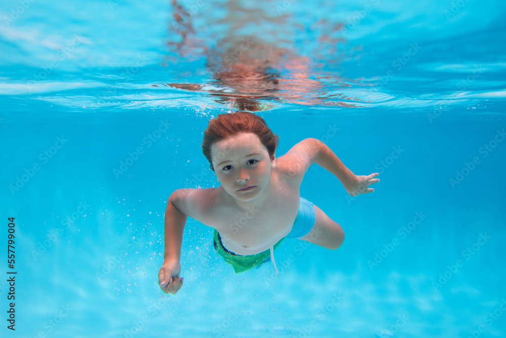 Summer kids in sea water on beach. Underwater child swims in pool ...