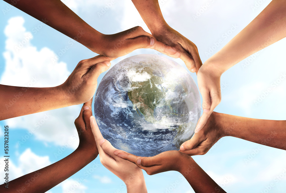 Conceptual symbol of multiracial human hands surrounding the Earth ...