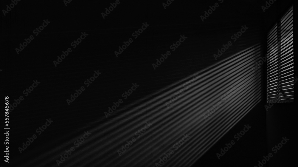 interior of dark room. shadow of the rays falling on the wall through ...