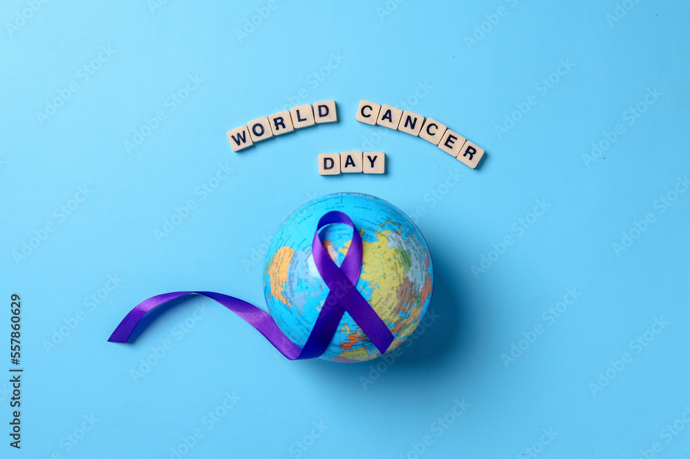 Globes with purple ribbon cancer awareness with word world cancer day ...