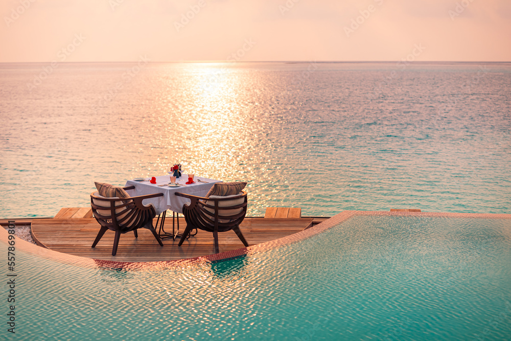 Seascape view under sunset light with dining table with infinity pool ...