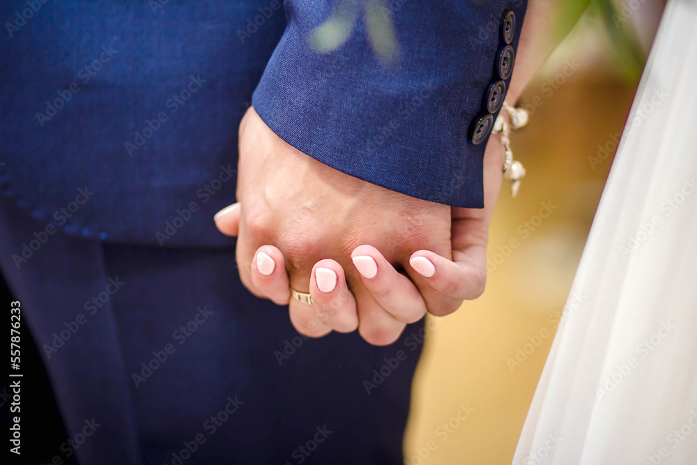 Young married couple holding hands, ceremony wedding day Stock Photo ...