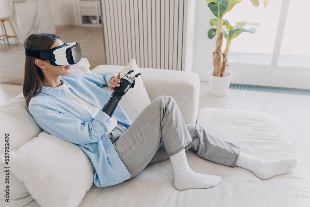 Disabled girl relaxing in vr glasses on couch. Handicapped person ...
