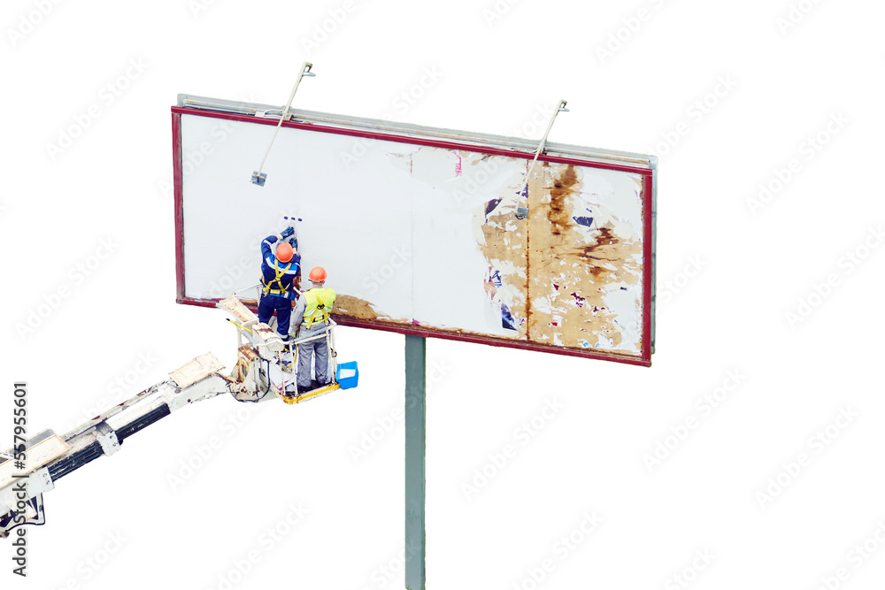 Workers upgrading billboard outdoor, on roadside of city street ...