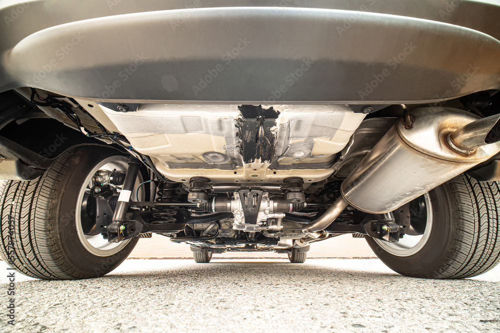 Auto mechanic view of bottom of the car. Rear differential axle wide ...
