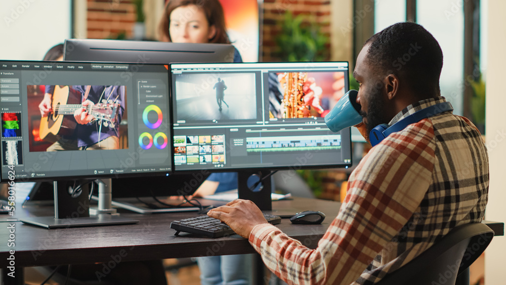 African american employee editing video content on multimedia software ...