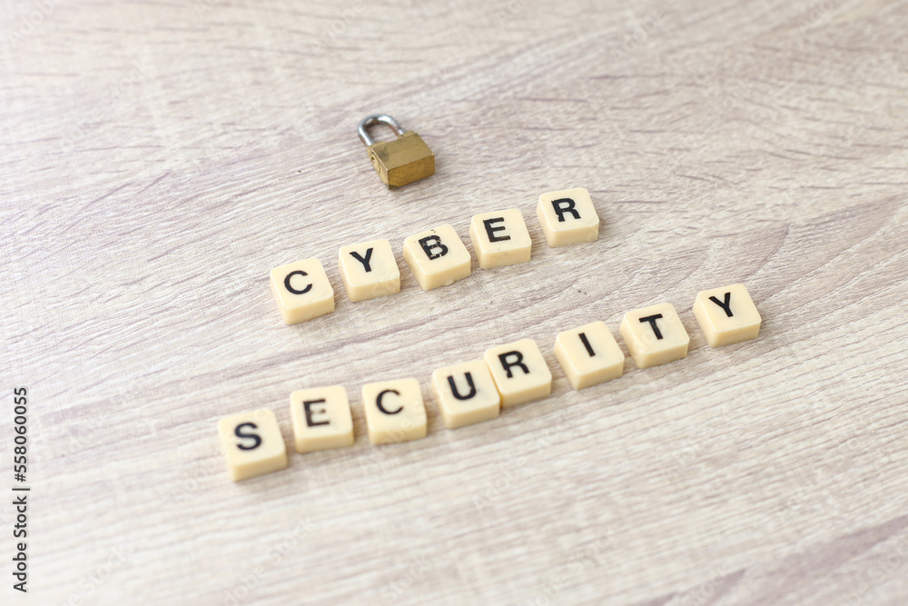 Lock and alphabet square tiles with the word cyber security on wooden ...